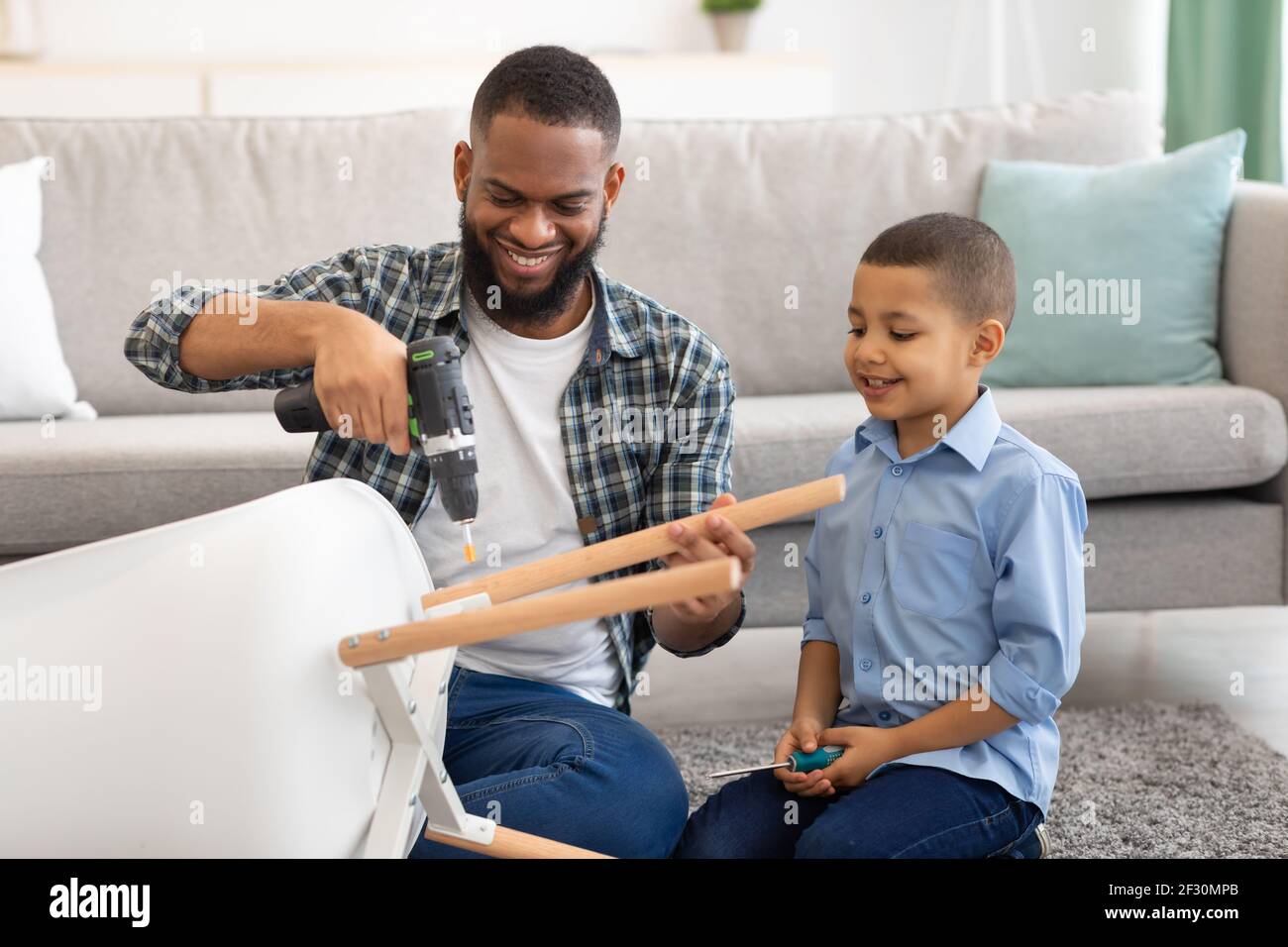 Boy helping with household chores hi-res stock photography and images ...