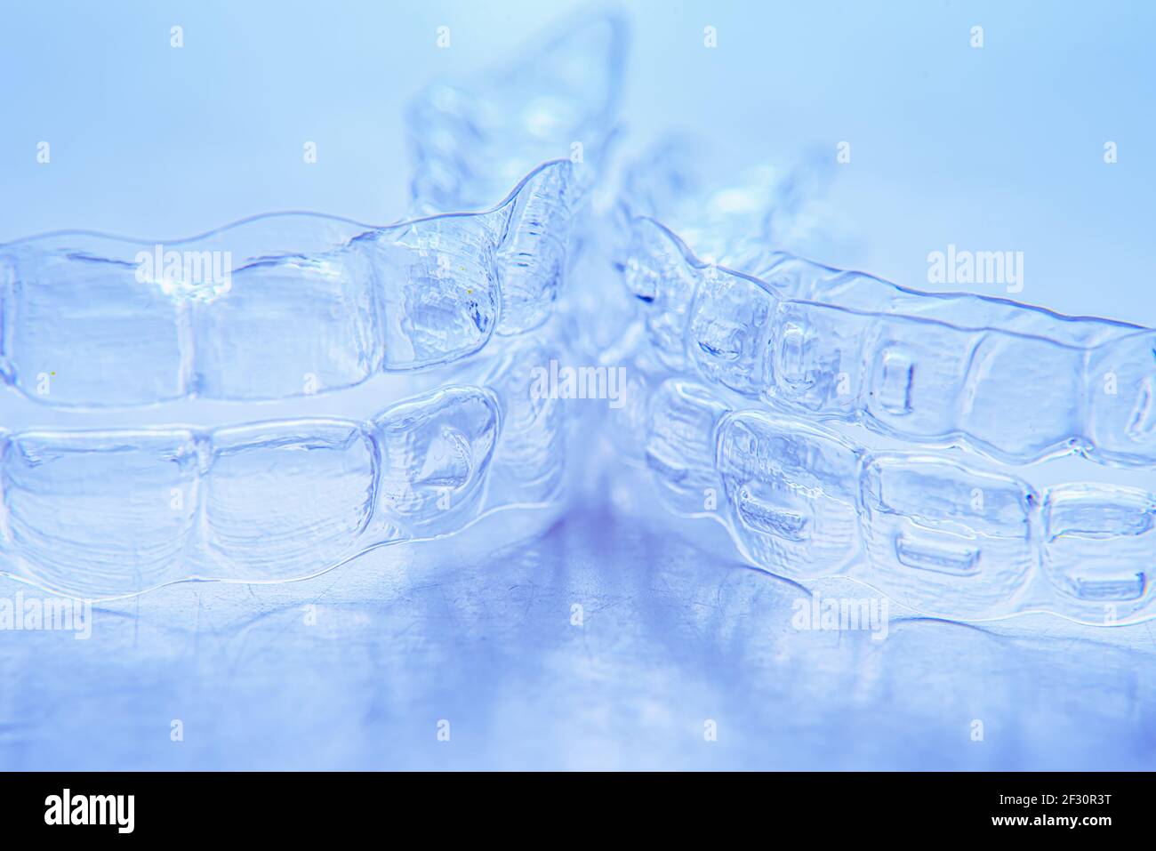 Invisible dental teeth brackets tooth aligners on blue background ...
