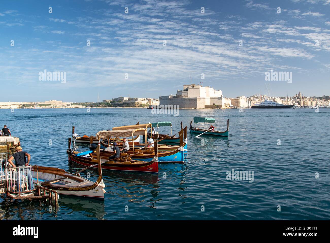 Water taxi operators waiting for fares. Dgħajsa tal-pass is a ...