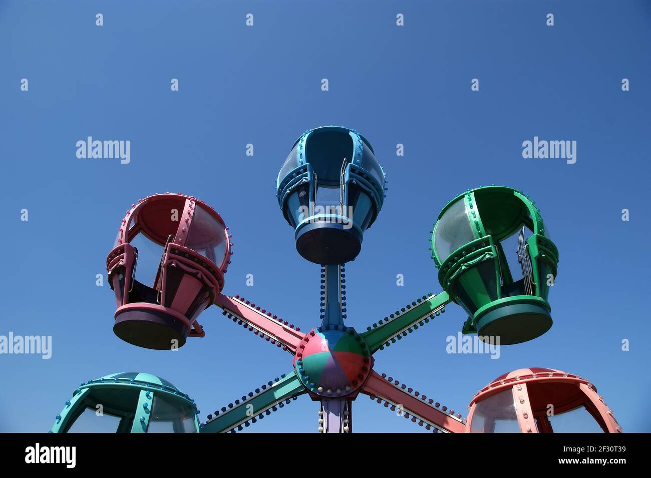 Booths children carousel at the blue sky Stock Photo - Alamy