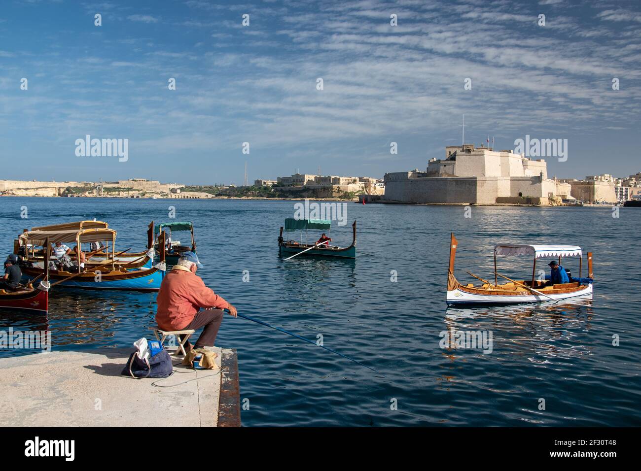 Water taxi operators waiting for fares. Dgħajsa tal-pass is a ...