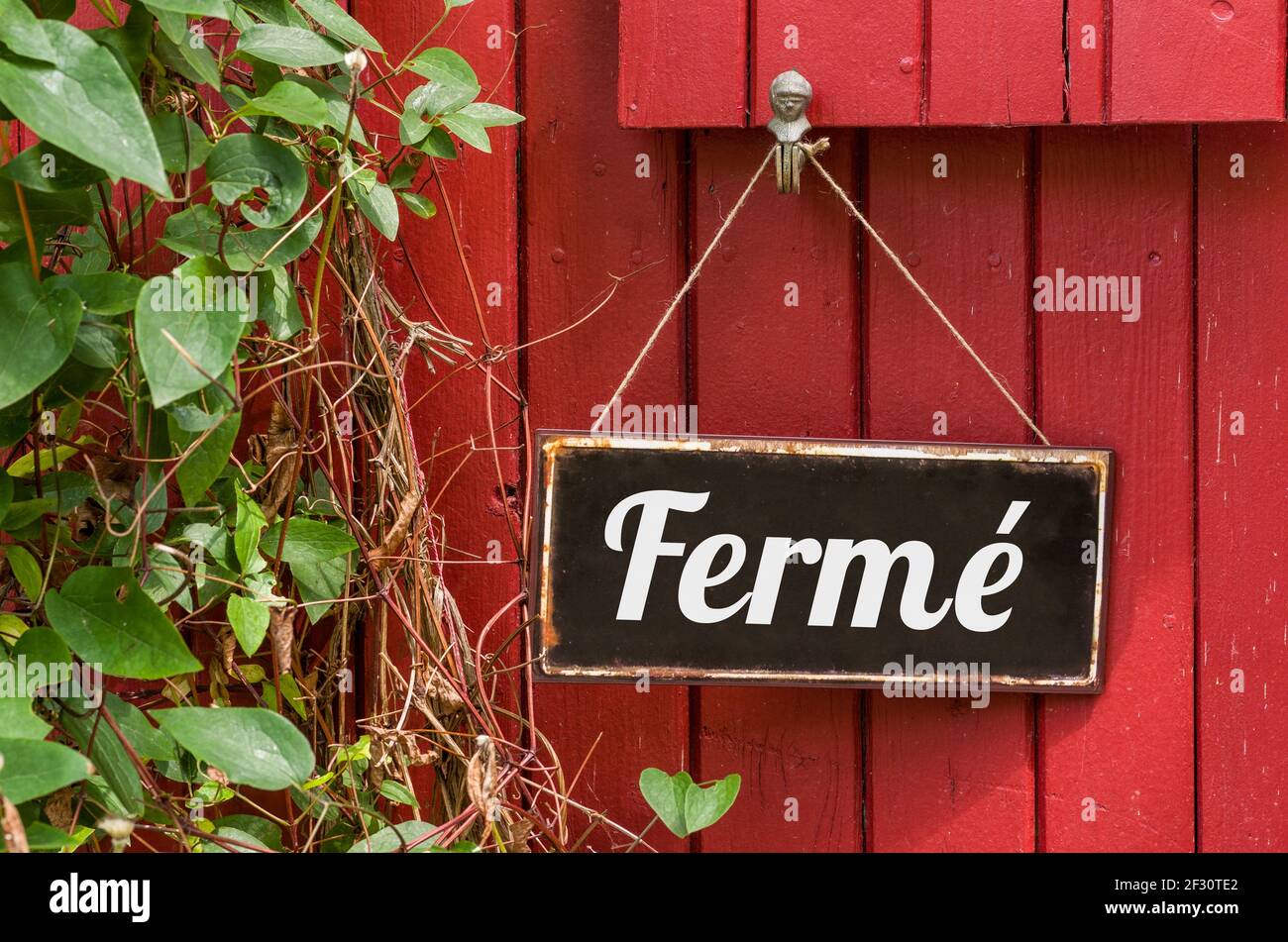 Old metal sign with the inscription Closed in french - Fermé Stock ...