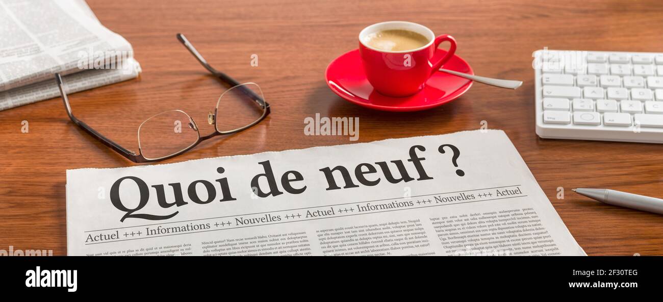 A newspaper on a wooden desk - Whats new in french - Quoi de neuf Stock ...