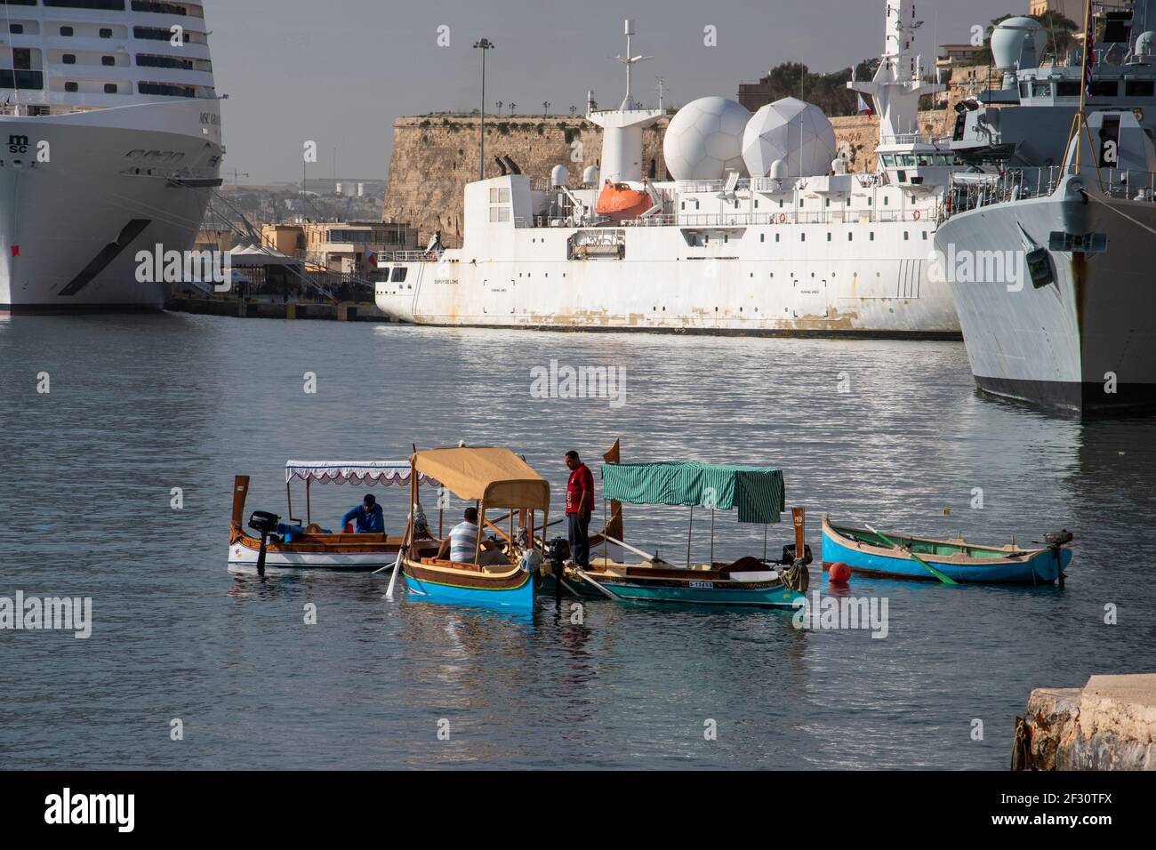 Water taxi operators waiting for fares. Dgħajsa tal-pass is a ...
