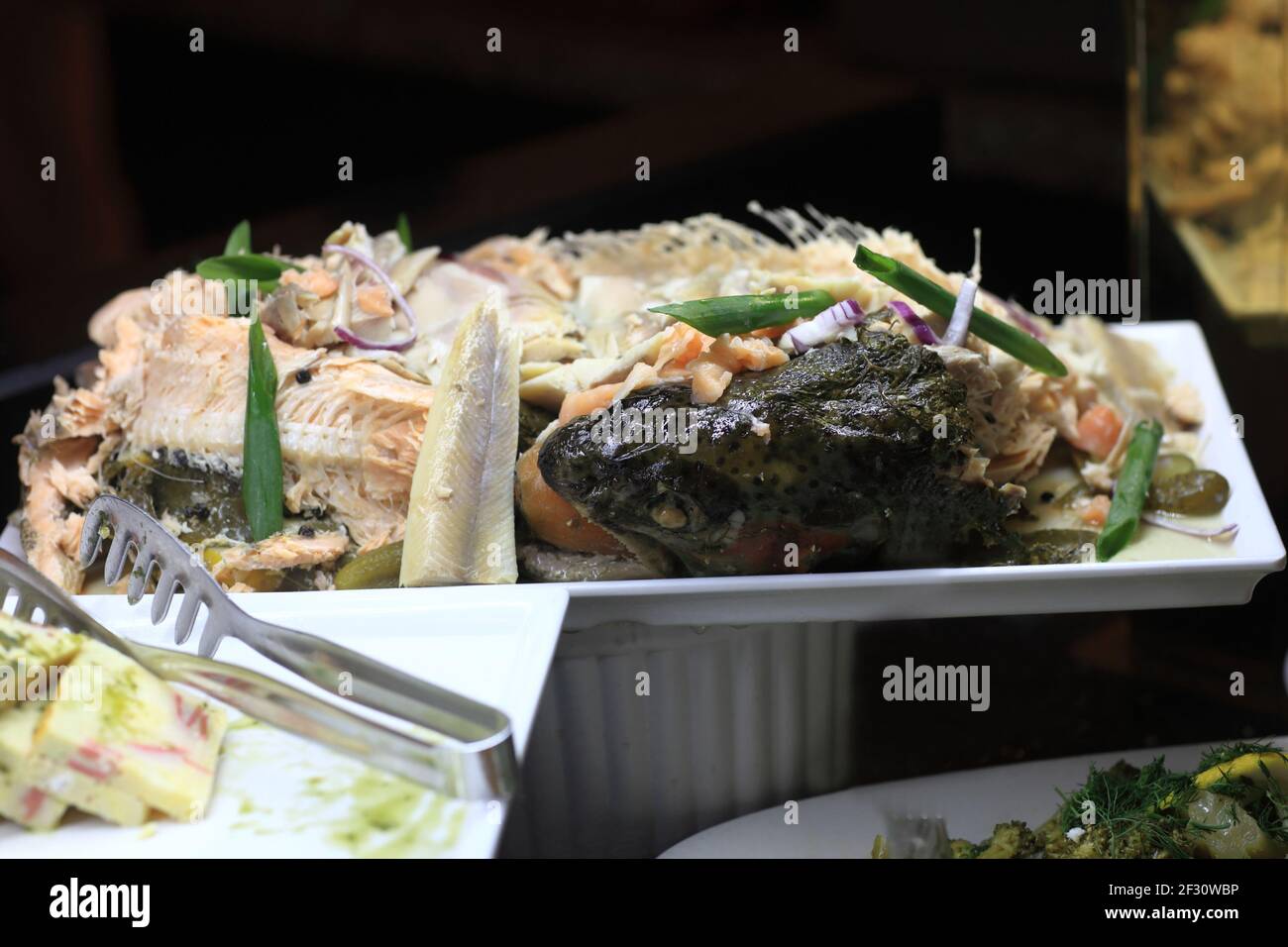 Baked fish on a tray at the buffet Stock Photo - Alamy
