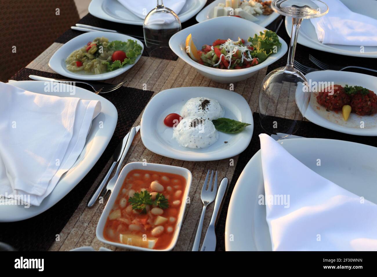 Dining table with assorted meze in a restaurant Stock Photo - Alamy