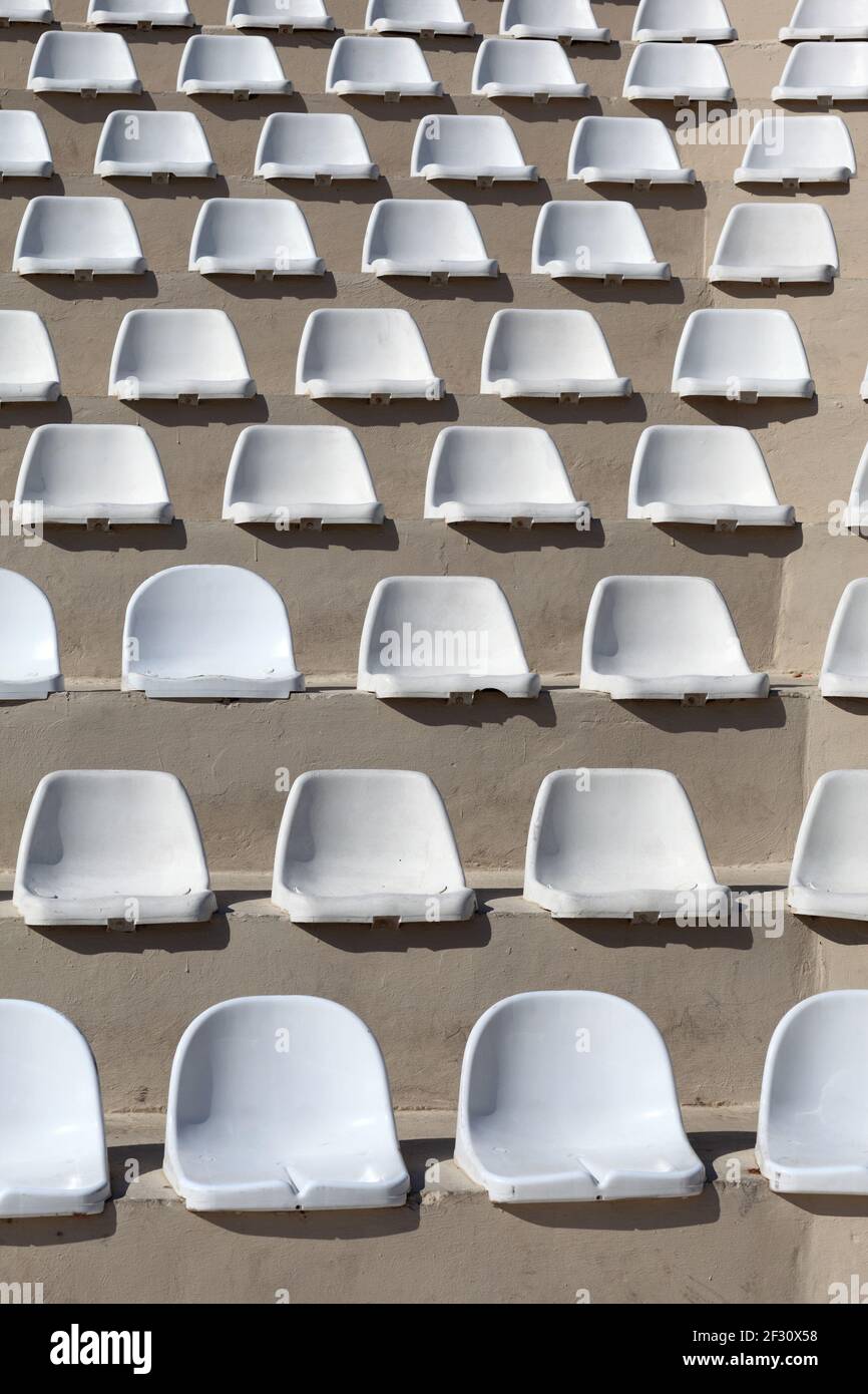 The white plastic seats in the outdoor stadium Stock Photo - Alamy