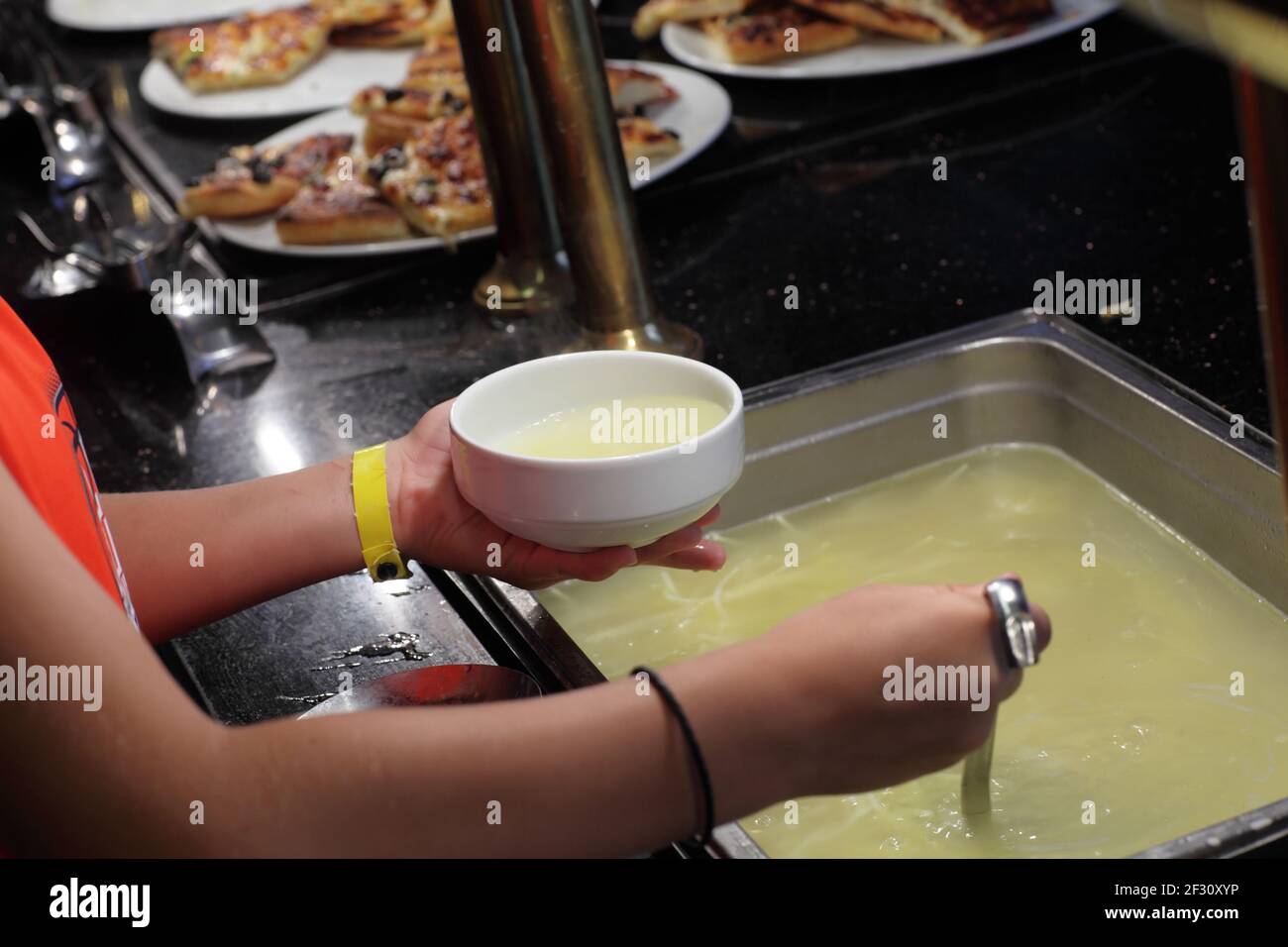 The person pouring broth at a buffet Stock Photo - Alamy