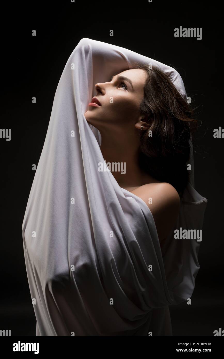 Woman wrapped in cloth outstretching arms in studio Stock Photo - Alamy