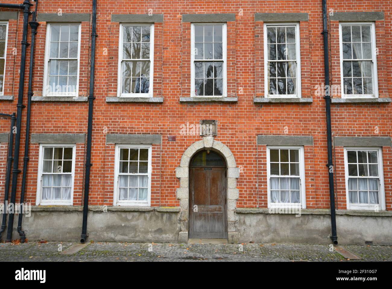 Exterior view of an old brick building on the grounds of Trinity ...