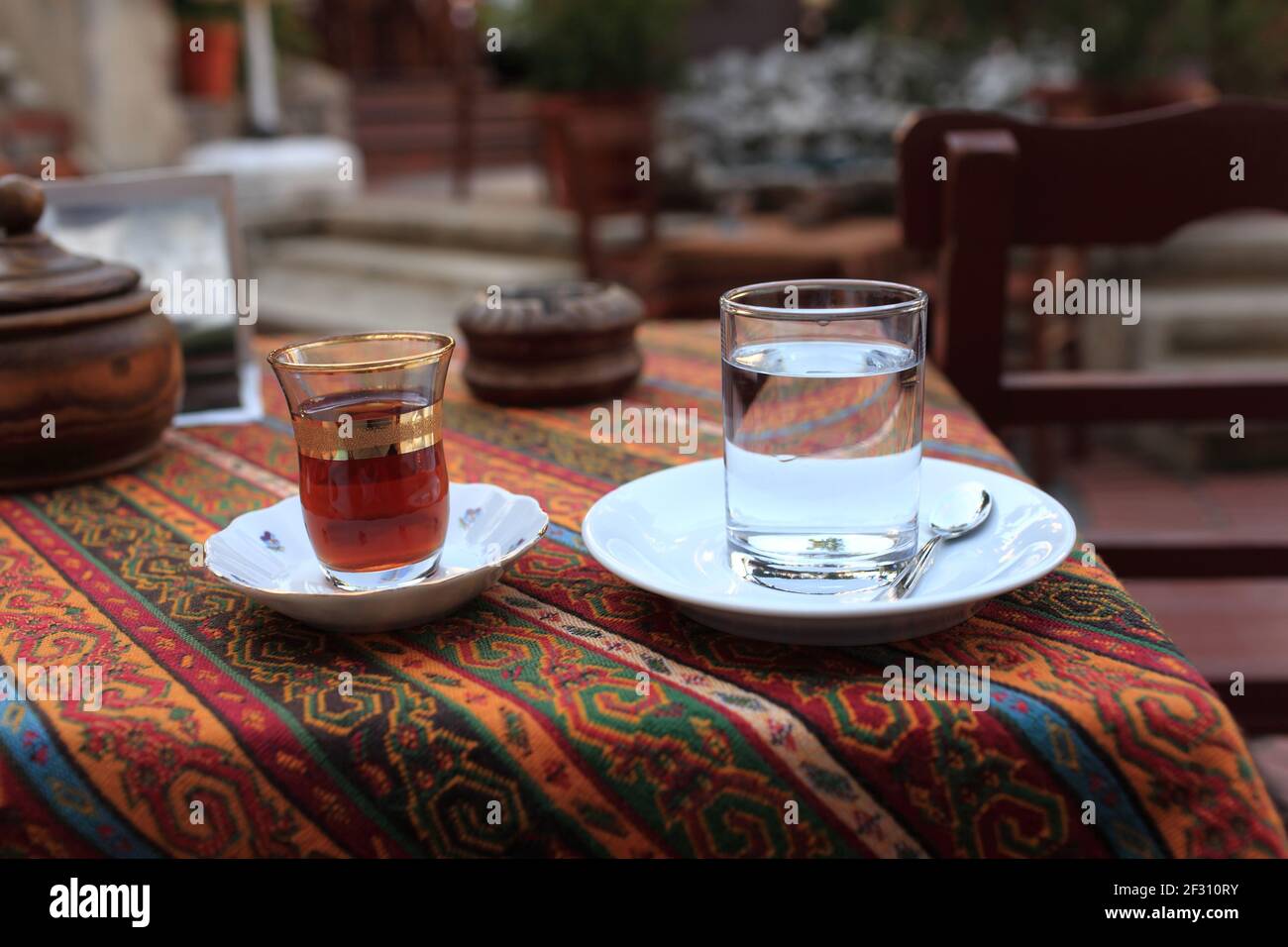 Cup of turkish tea and glass of water on a table Stock Photo - Alamy