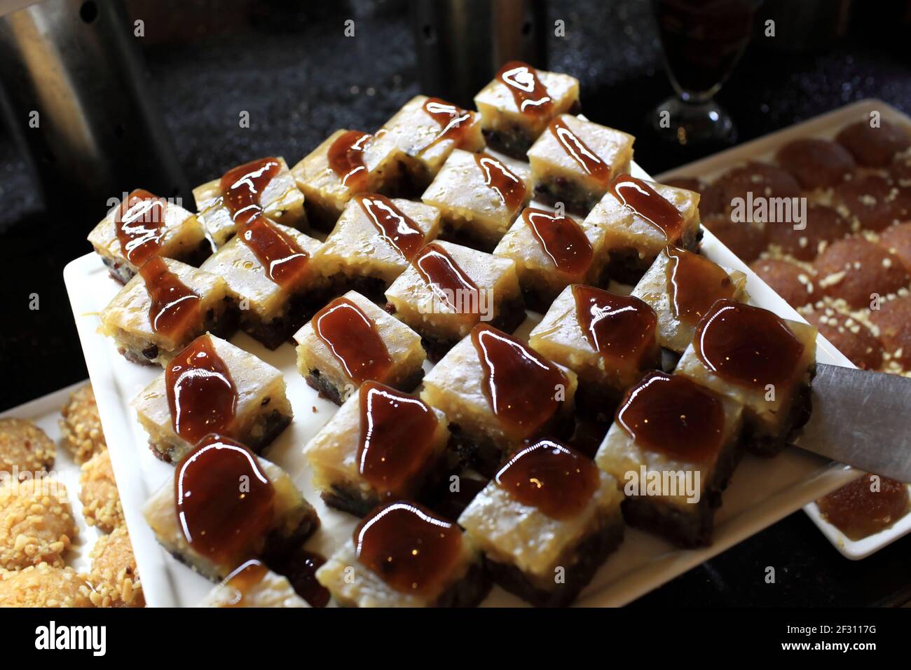 Pieces of cake with syrup at the buffet Stock Photo - Alamy