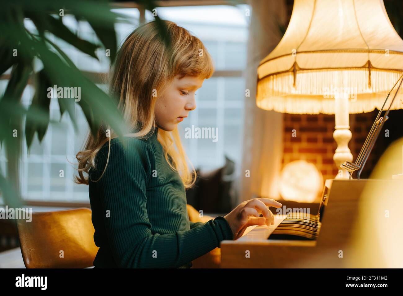 young girl playing keyboard at home Stock Photo - Alamy