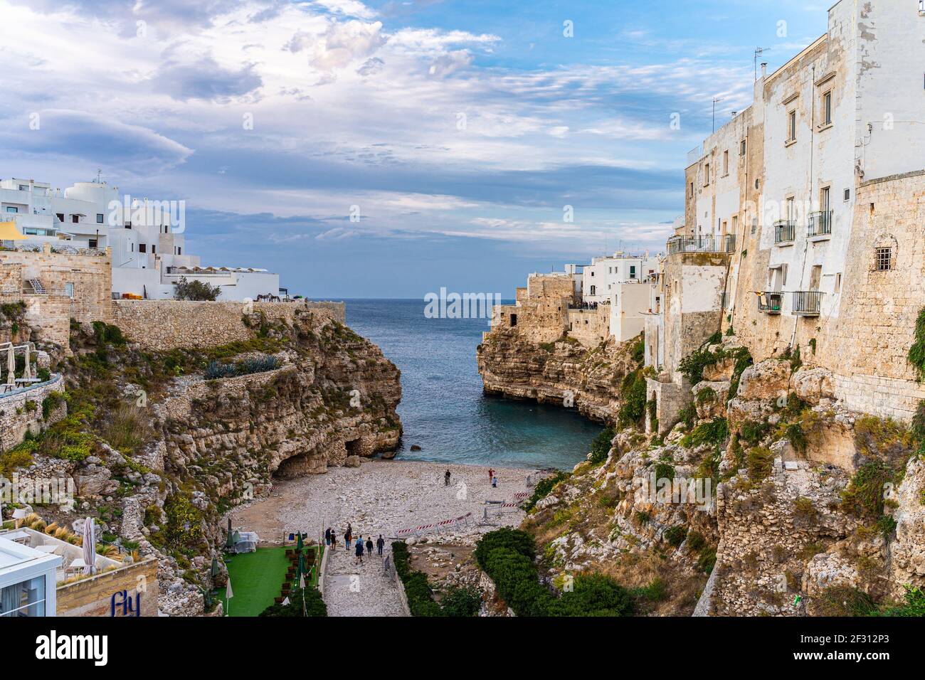 The beach of Polignano a Mare with its steep cliffs of the old town ...