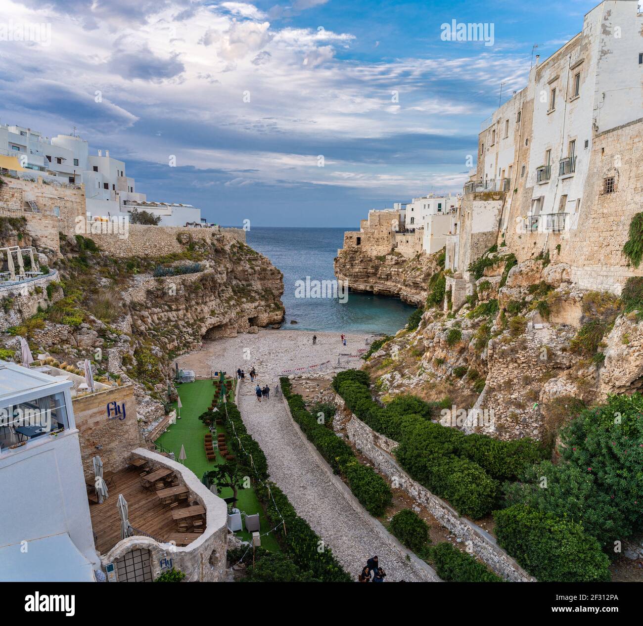 The beach of Polignano a Mare with its steep cliffs of the old town ...