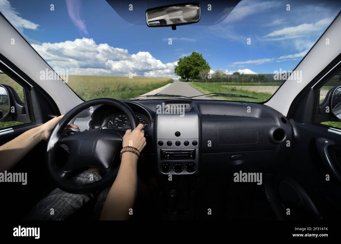 Car driver driving on small country road tranquil scenic landscape ...