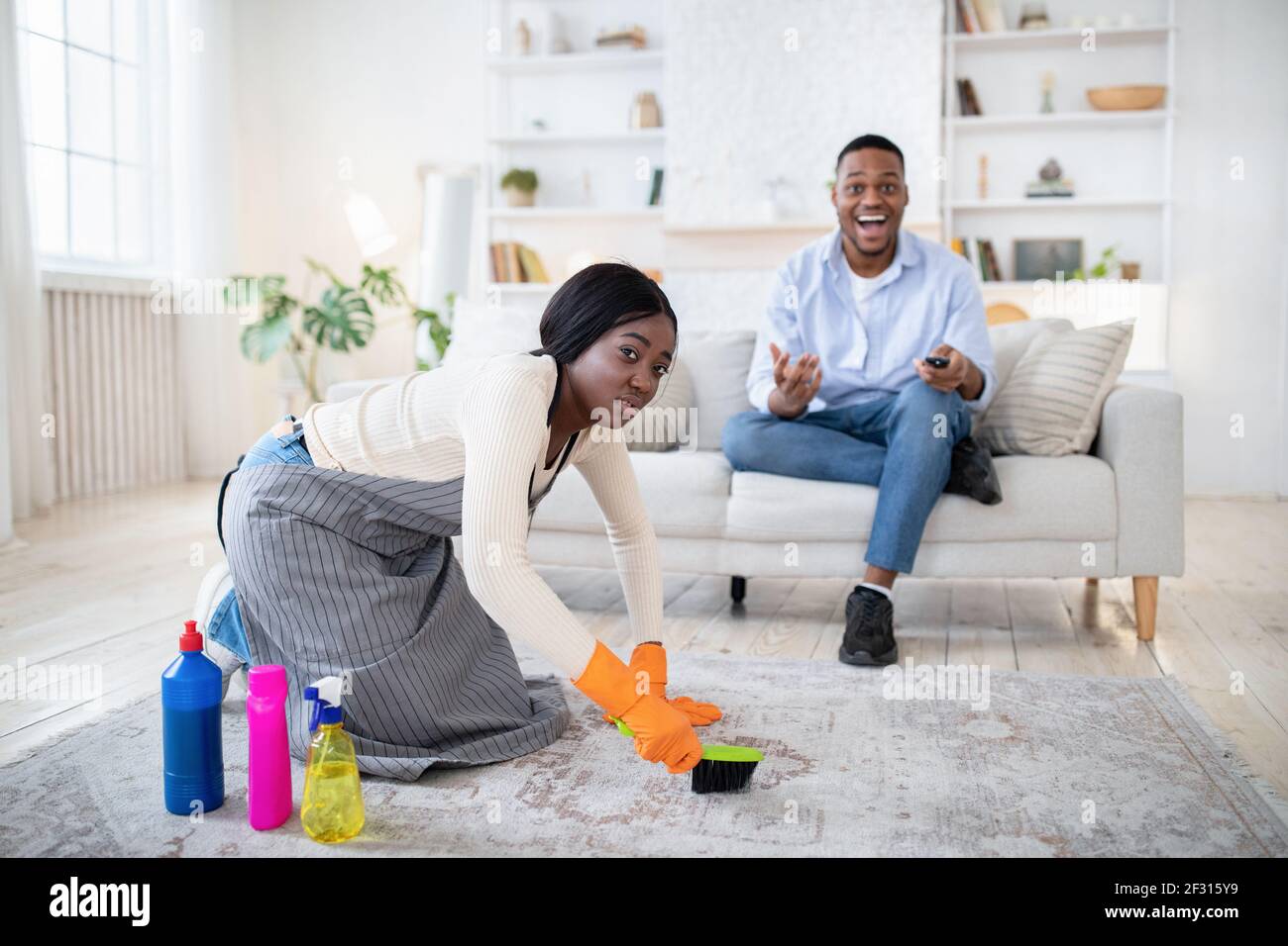 Woman housework lazy man hi-res stock photography and images - Alamy