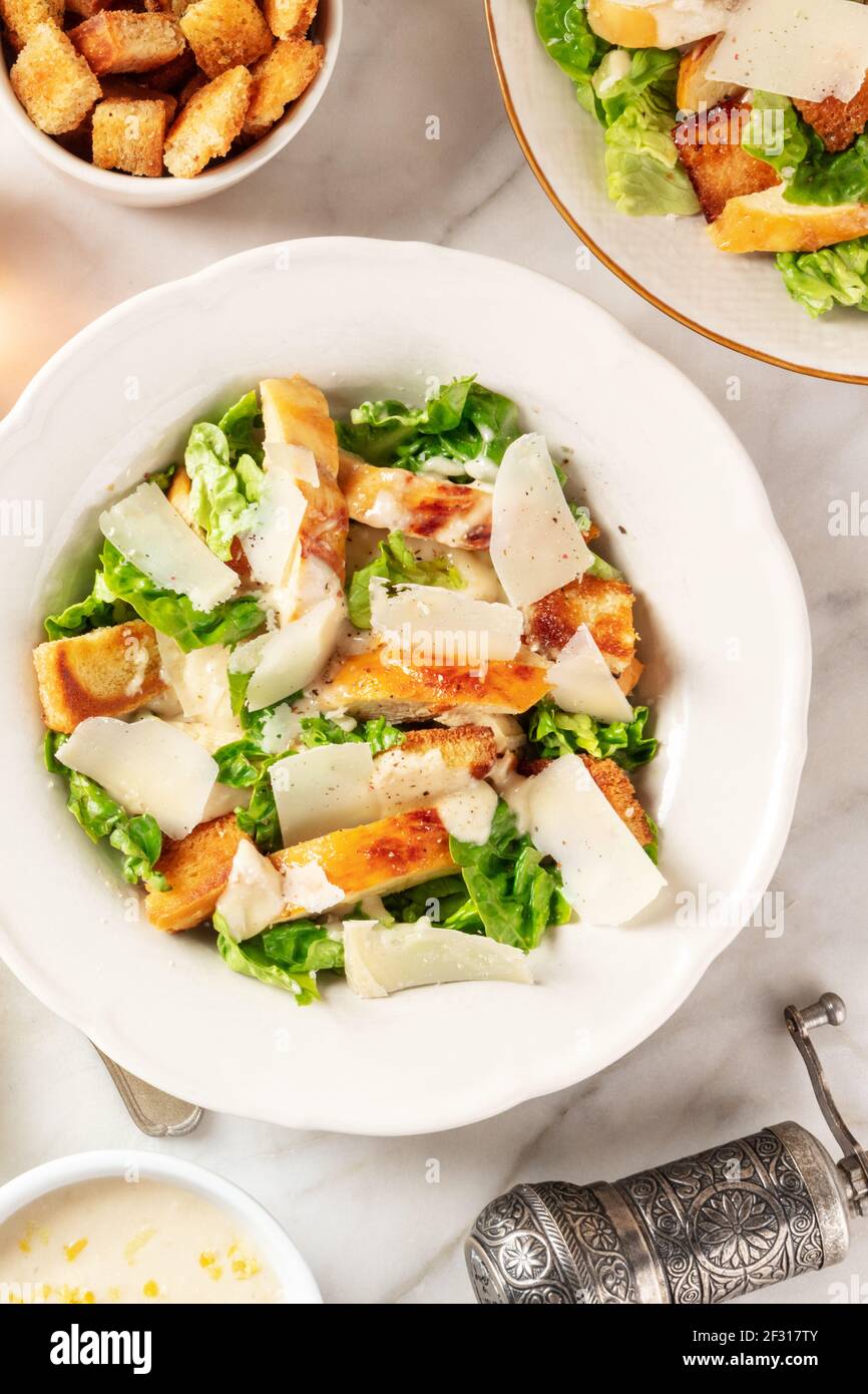 Traditional classic caesar salad in white plate hi-res stock ...