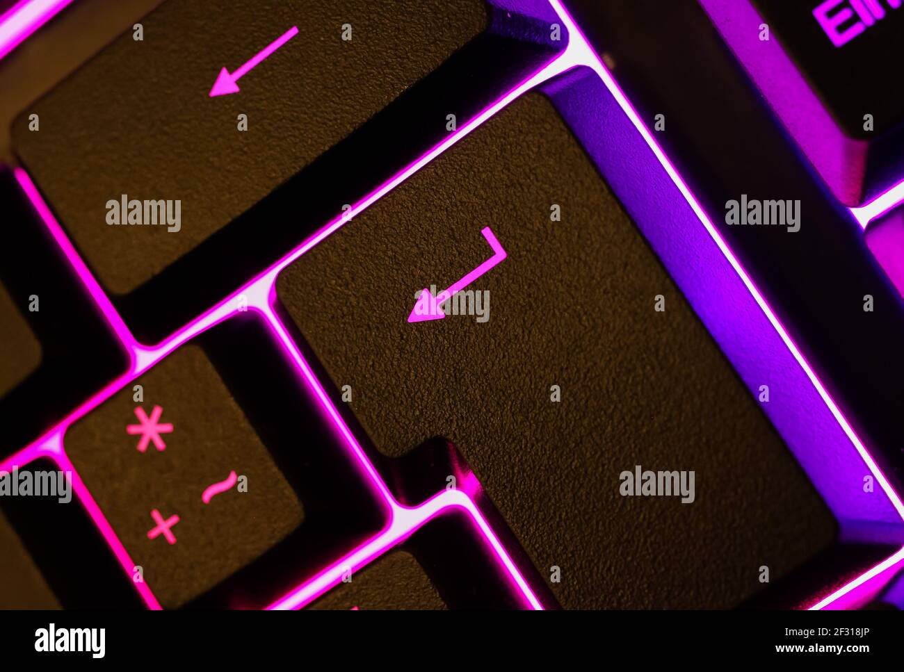 Macro closeup of pink purple illuminated return key on computer ... Macro closeup of pink purple illuminated return key on computer ...