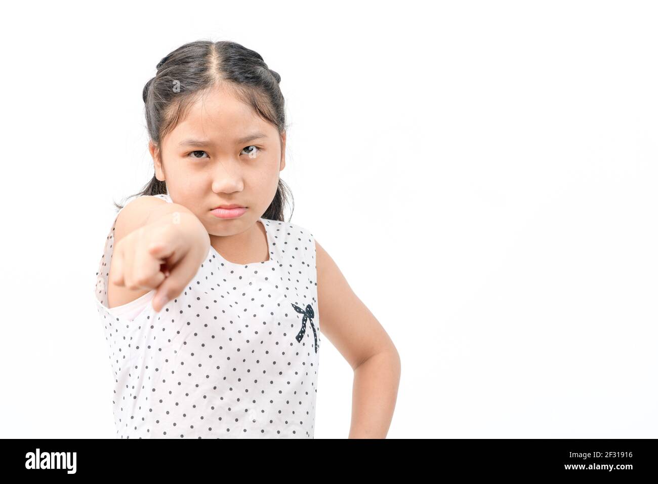 Portrait angry kid girl pointing finger at camera screaming isolated on ...