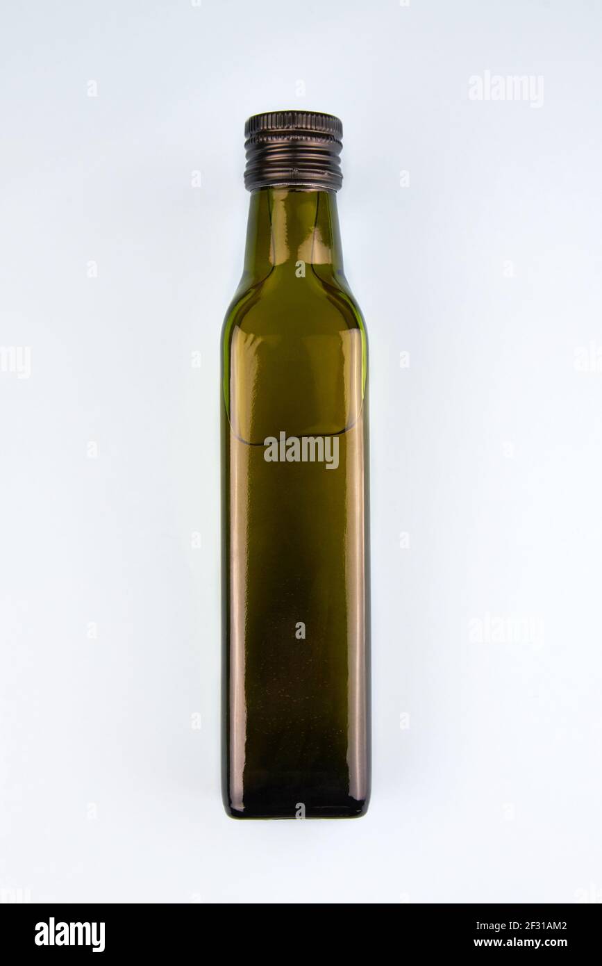 Green transparent glass bottle of olive oil on a light background Stock ...