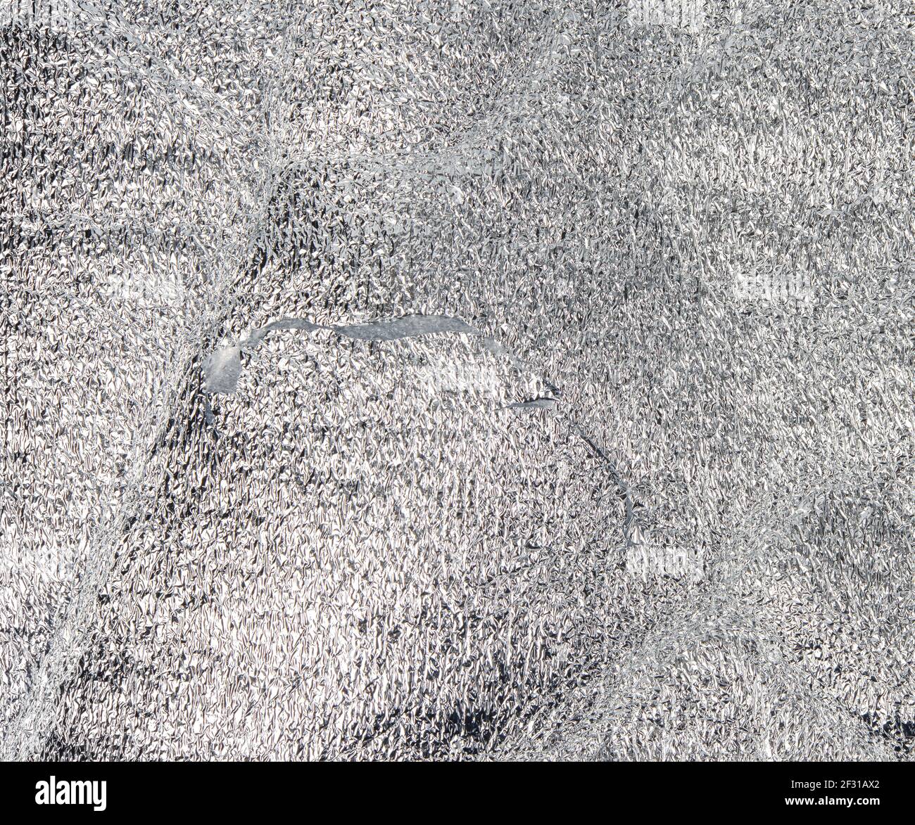 Texture of insulating and warming foil and neoprene material, full ...