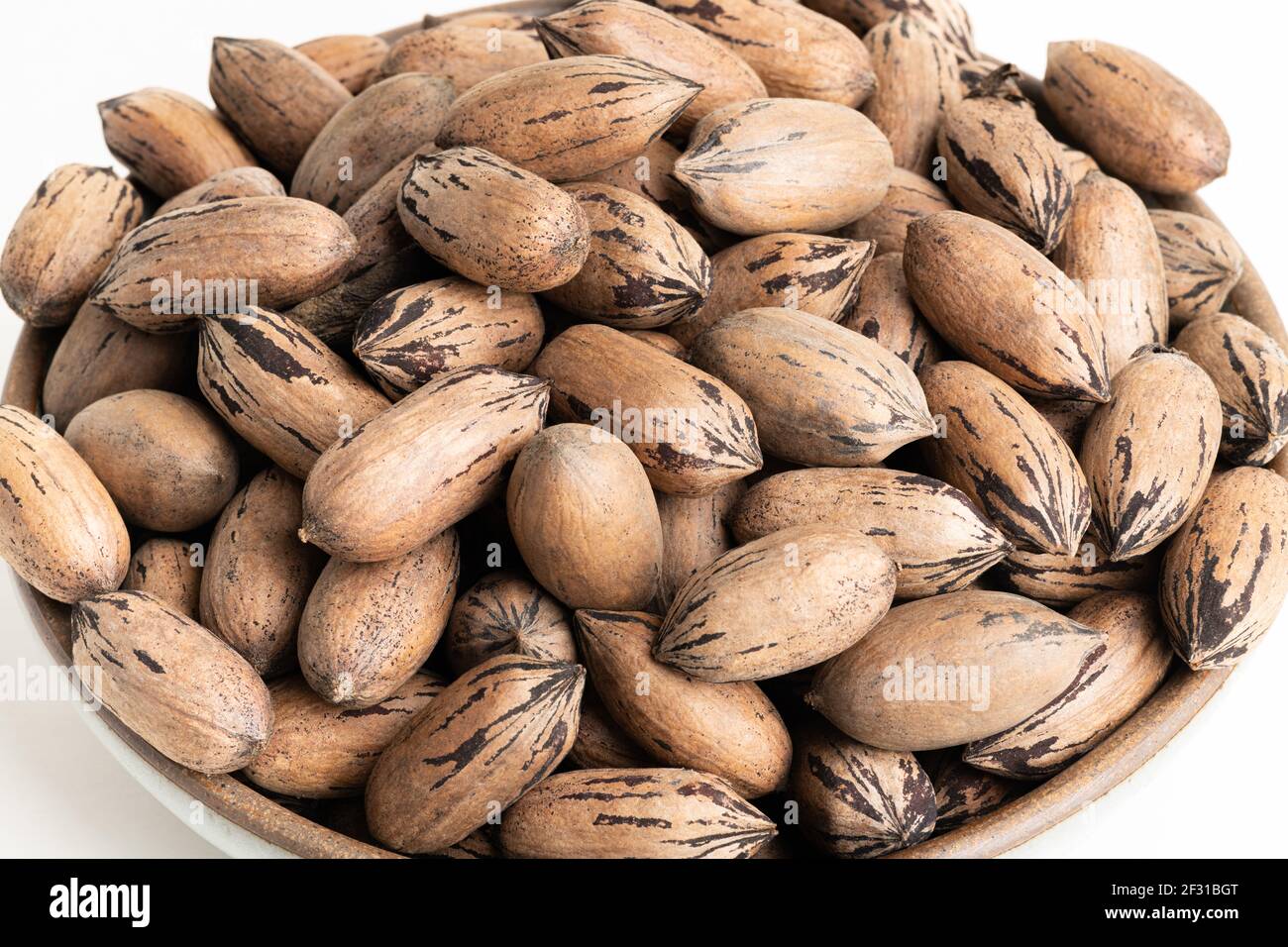 In-shell pecan nuts on bowl set on plain white background Stock Photo ...