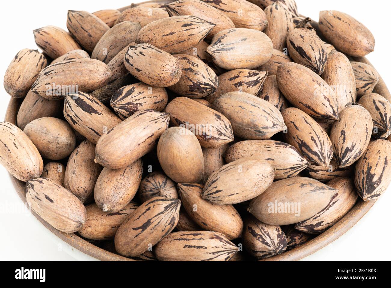In-shell pecan nuts on bowl set on plain white background Stock Photo ...