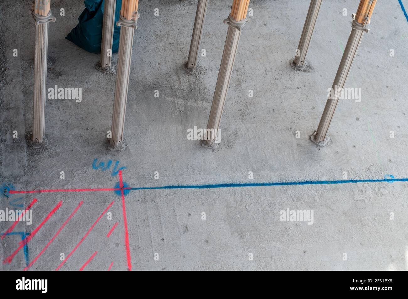 detail of a construction site with colorful markings on cement floor ...