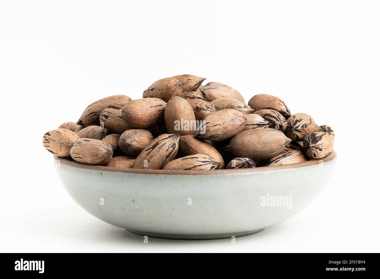 In-shell pecan nuts on bowl set on plain white background Stock Photo ...