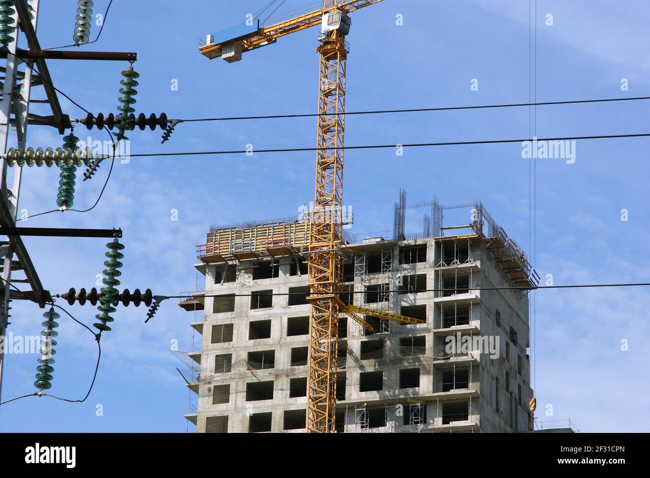 electric pylon and building crane at the background of building under ...