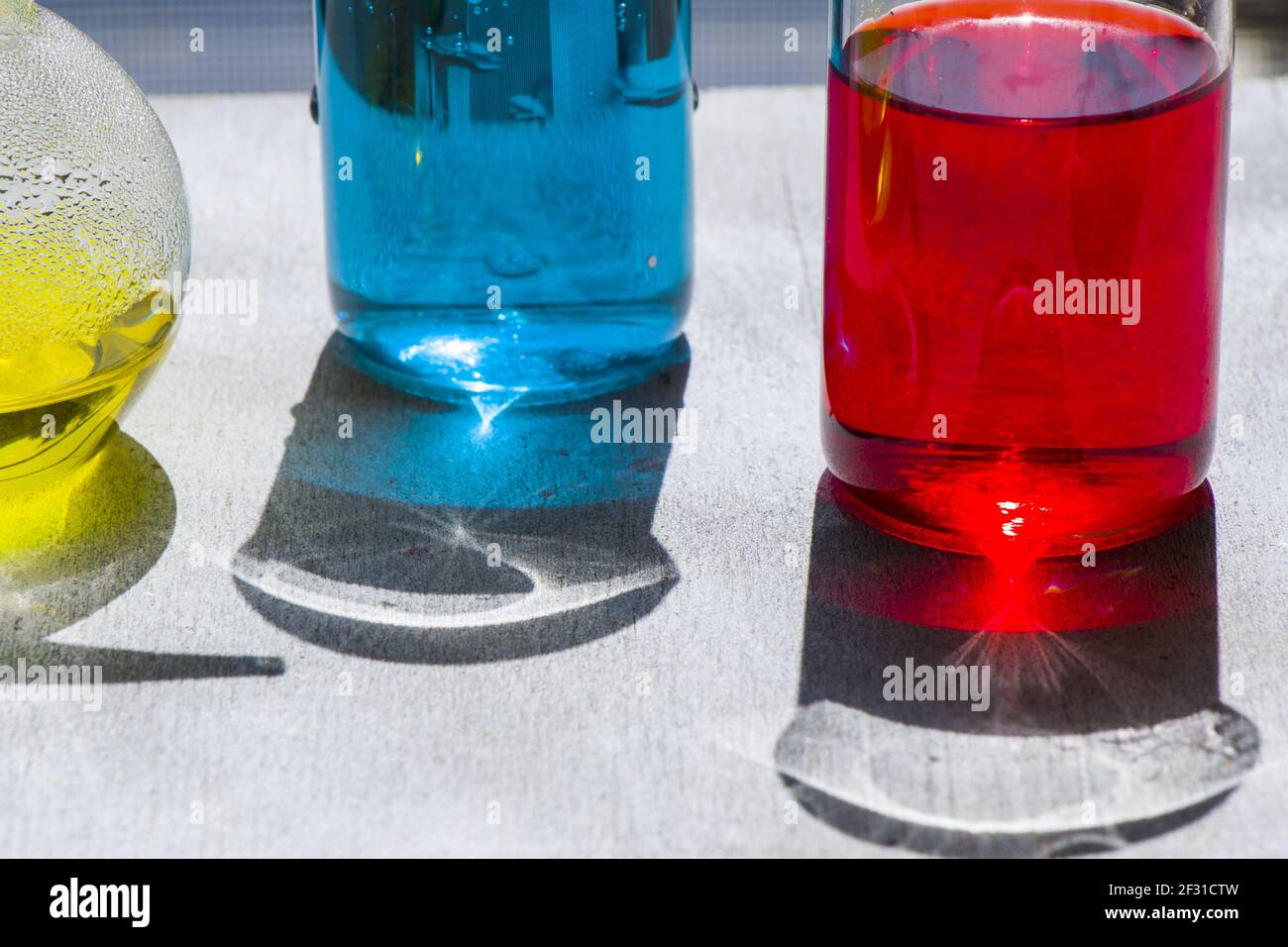 A closeup shot of laboratory glassware filled with red and blue color ...