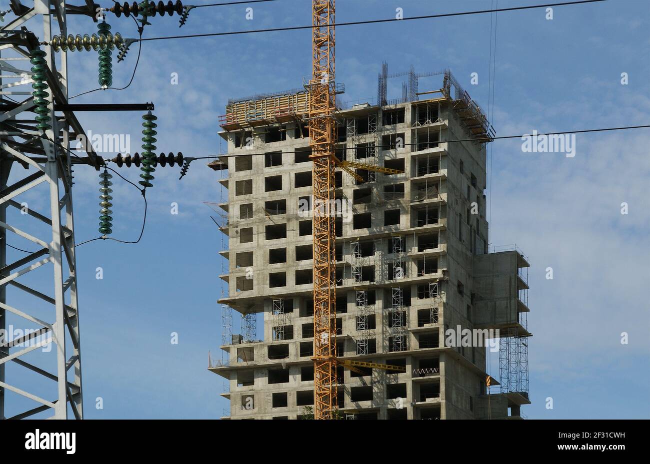 electric pylon and building crane at the background of building under ...