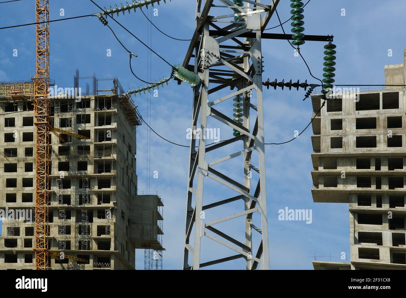 electric pylon and building crane at the background of building under ...