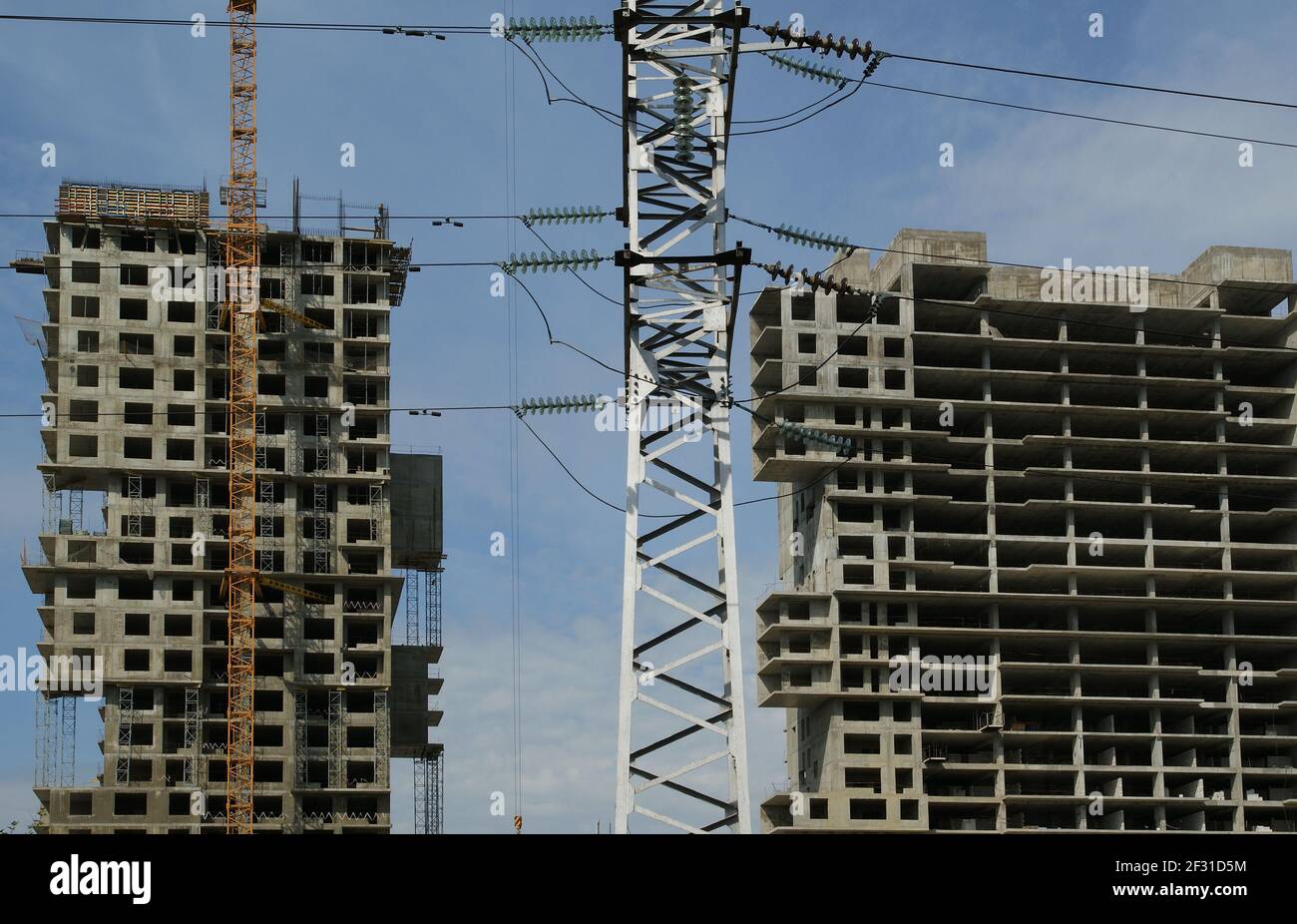 electric pylon and building crane at the background of building under ...