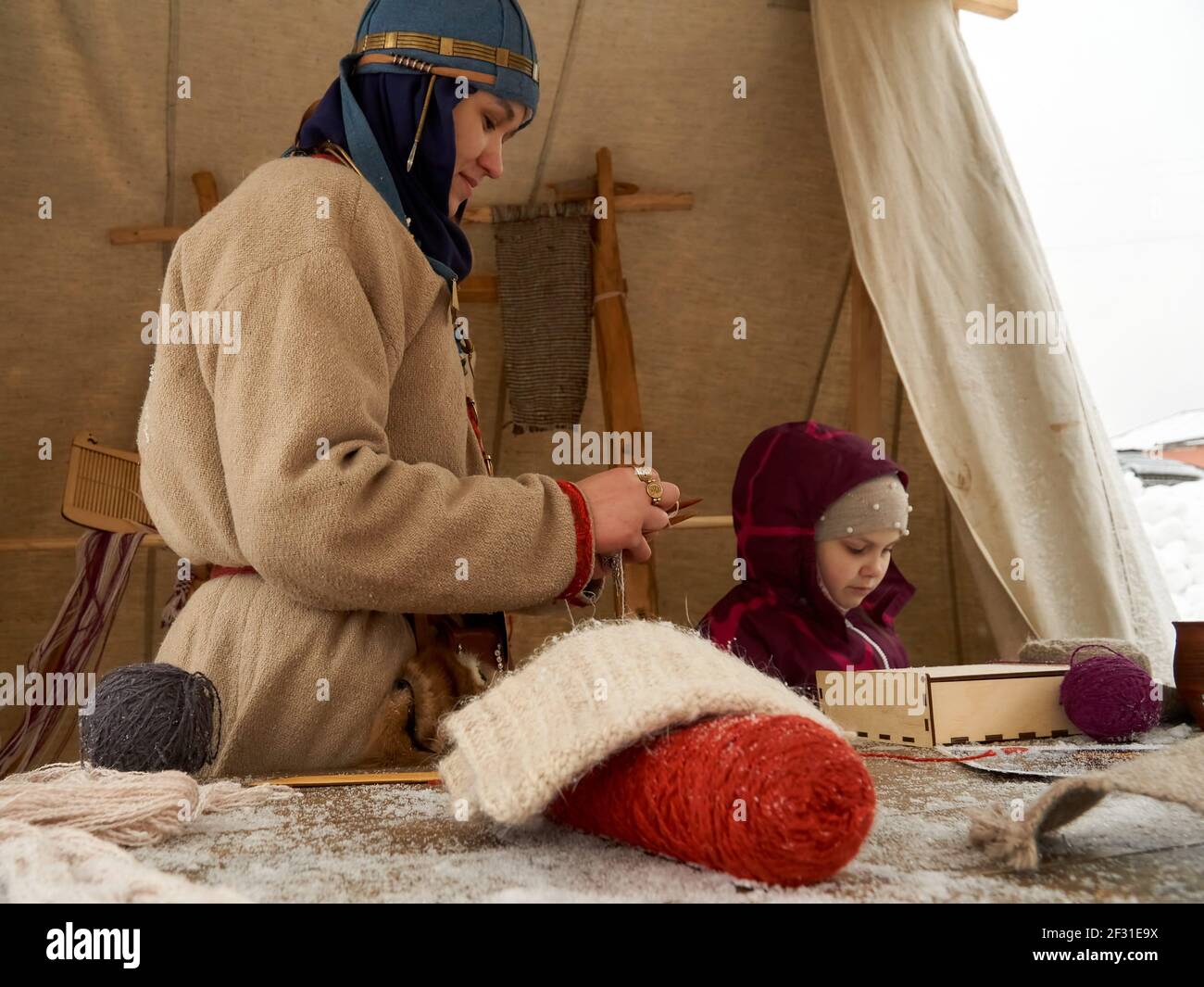 Moscow, Russia. 13th Mar, 2021. Historical reenactor knits some craft ...
