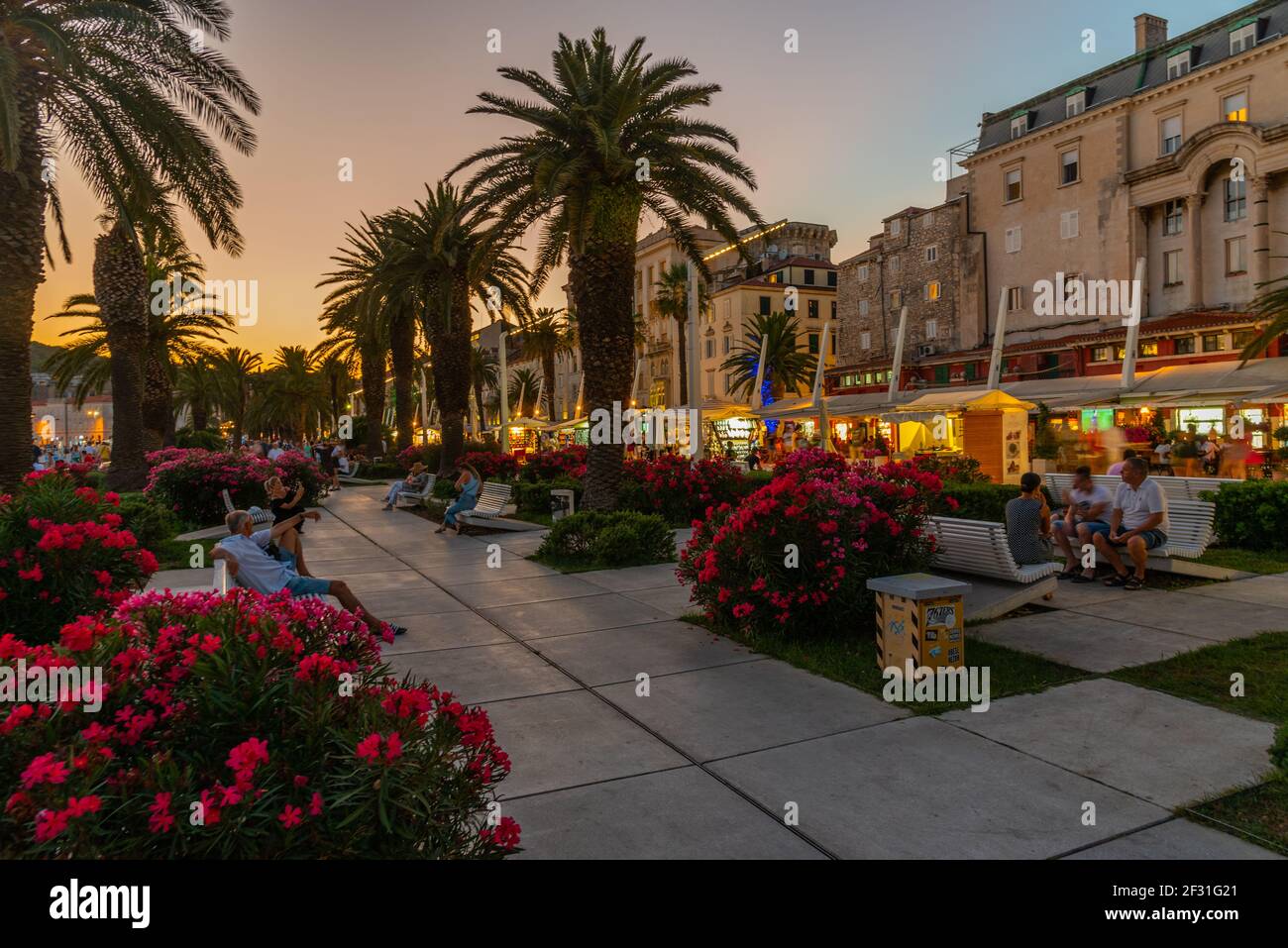 Split, Croatia, July 29, 2020: Night view of people walking on seaside ...