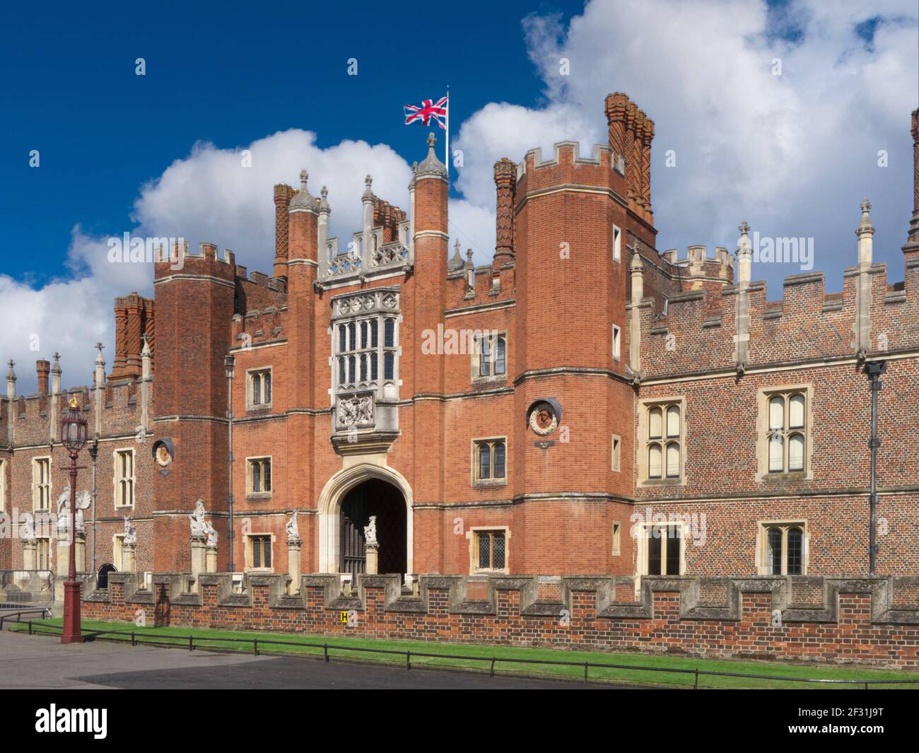 Hampton Court Palace west front entrance flying Union Jack Flag. A ...