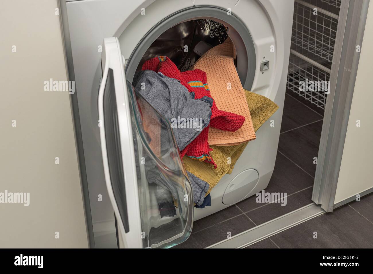 Close up view of washed laundry in a laundry machine. Home routine ...