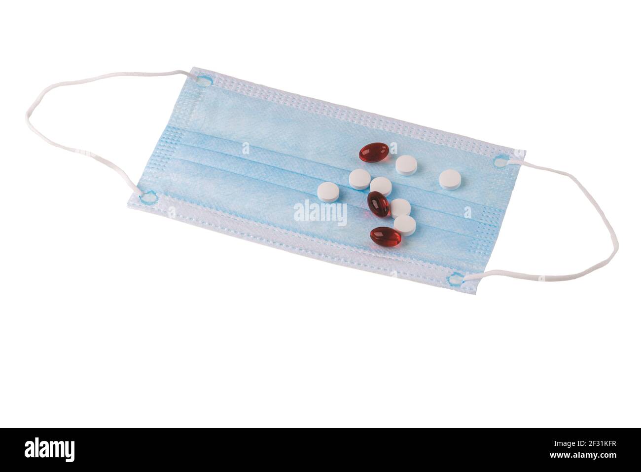 Close up view of tablets on blue face mask on white background Stock ...