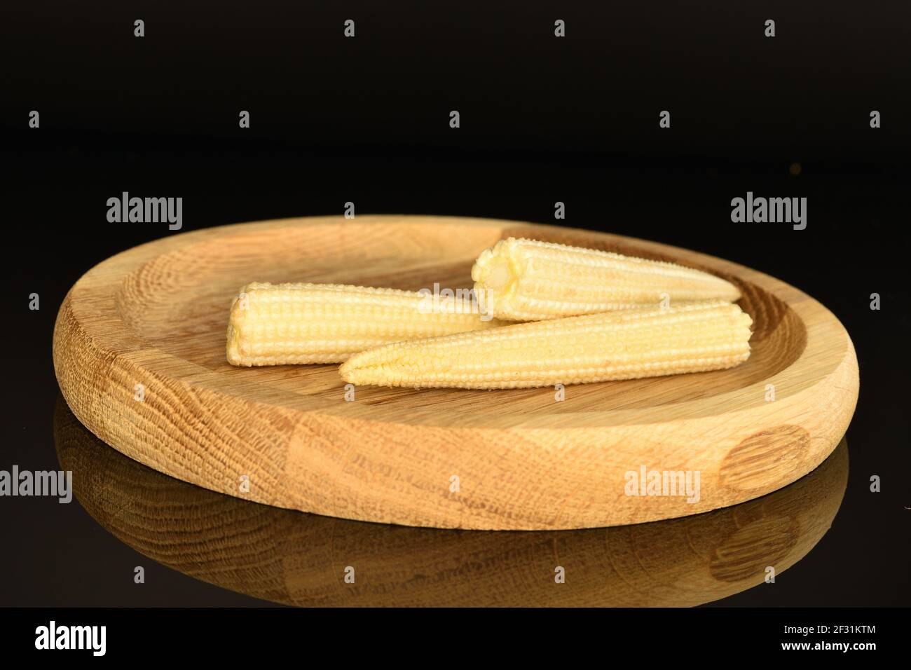 Several bright yellow ripe sweet organic mini corn with a jute bag ...