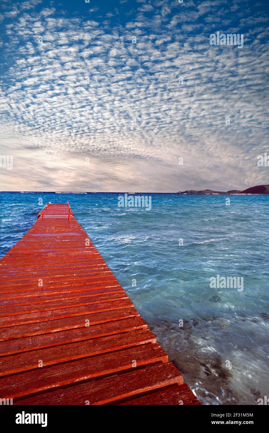 RED JETTY Necker Island rustic red wooden landing stage jutting out ...