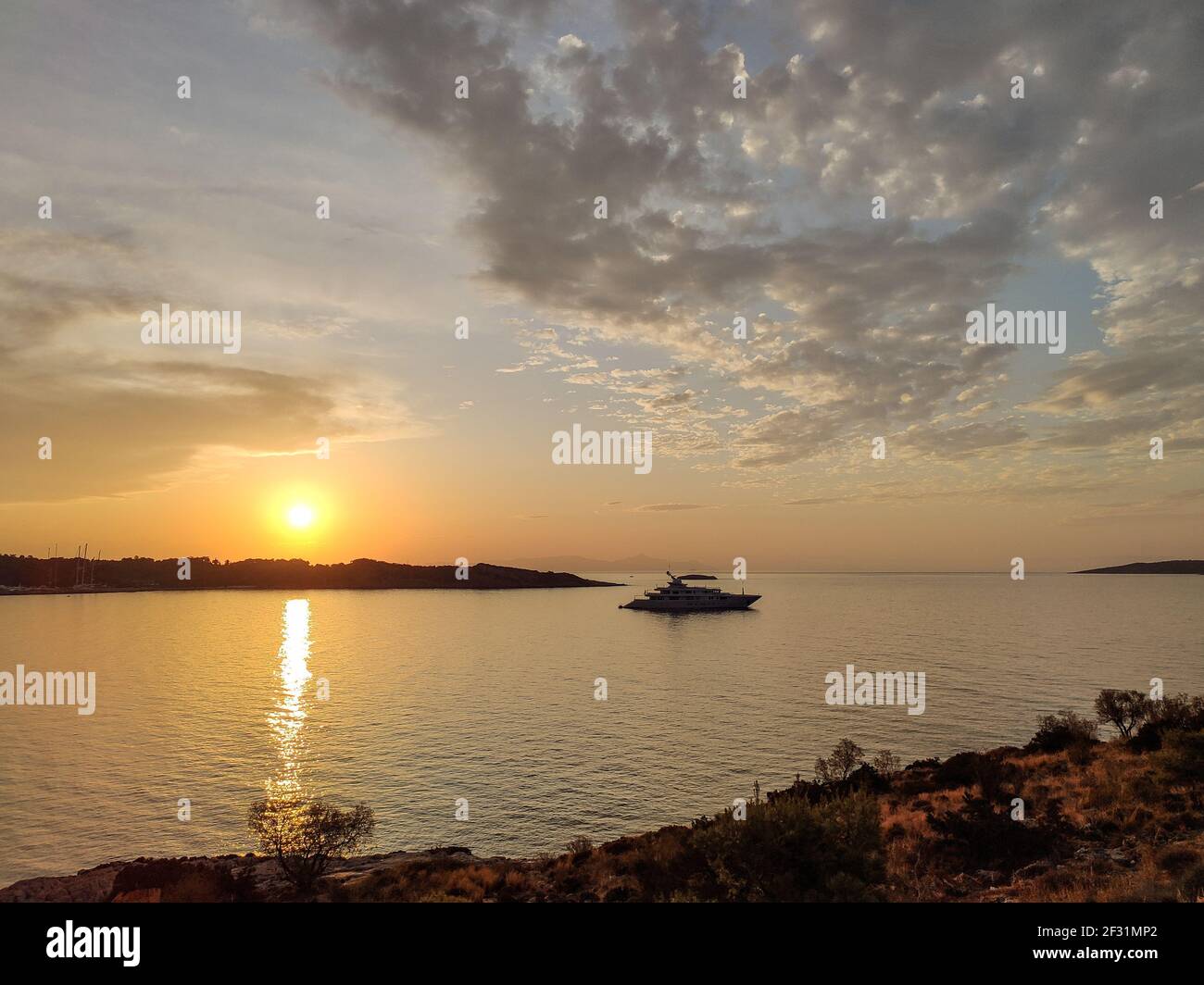 Orange sunset sun shining above Greek islands in Aegean sea in Greece ...