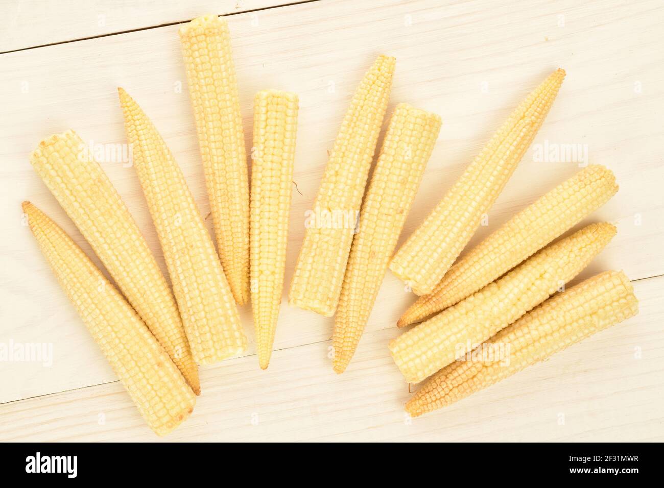 Several bright yellow ripe sweet organic mini corn, close-up, on a ...