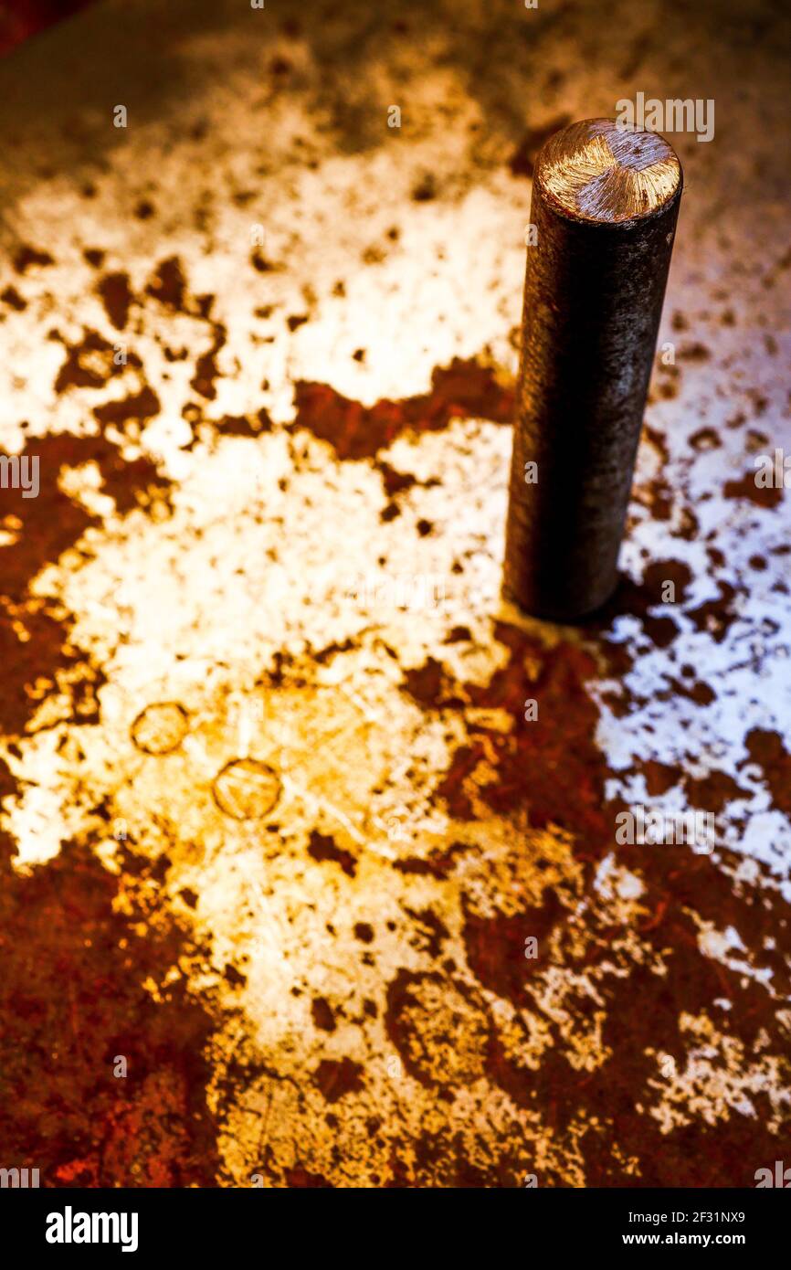 Cylindrical piece of metal putted on a rusted metal plate, Illustration ...