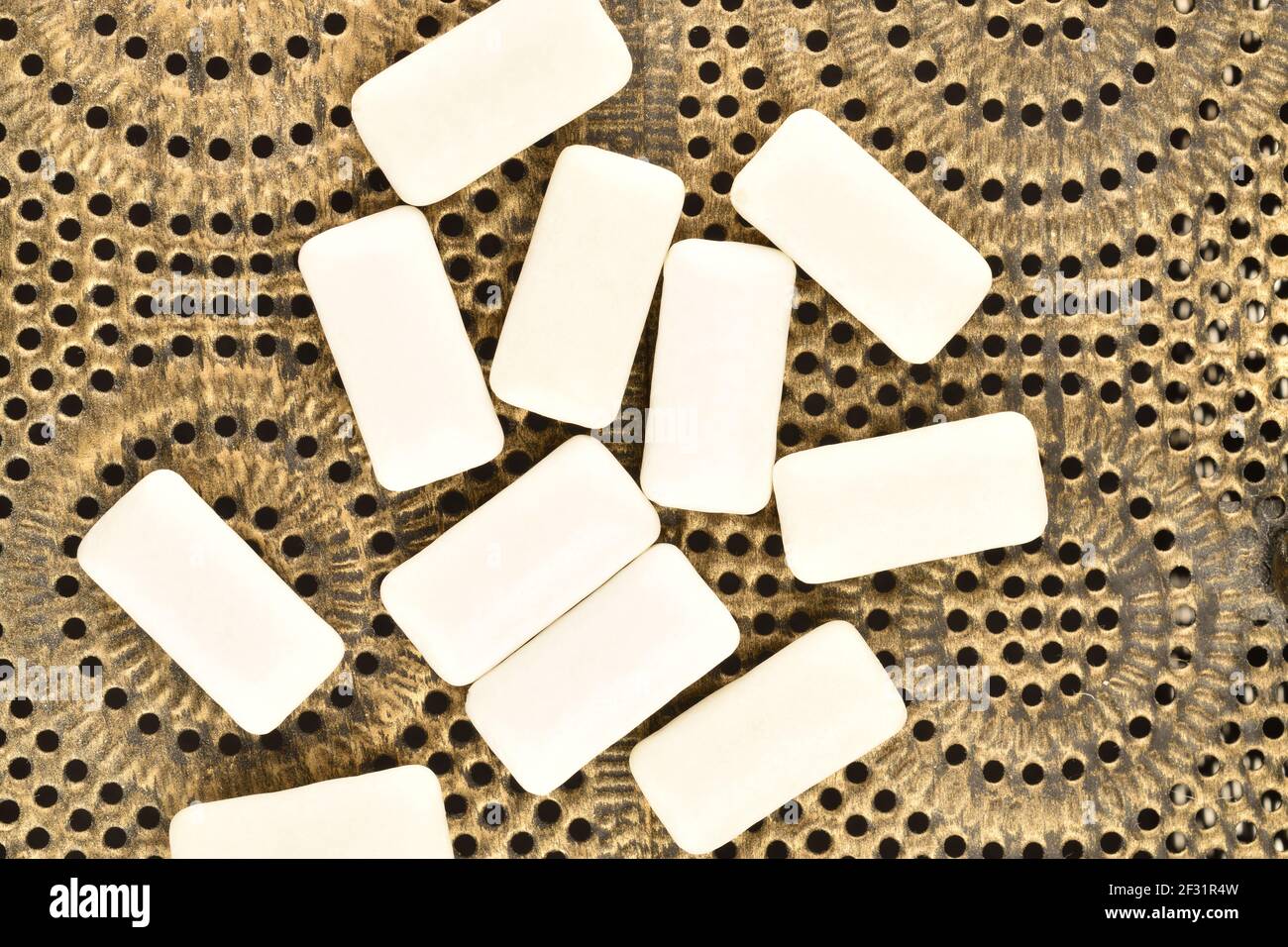 A few white fresh mint pads of chewing gum on a metal tray background ...