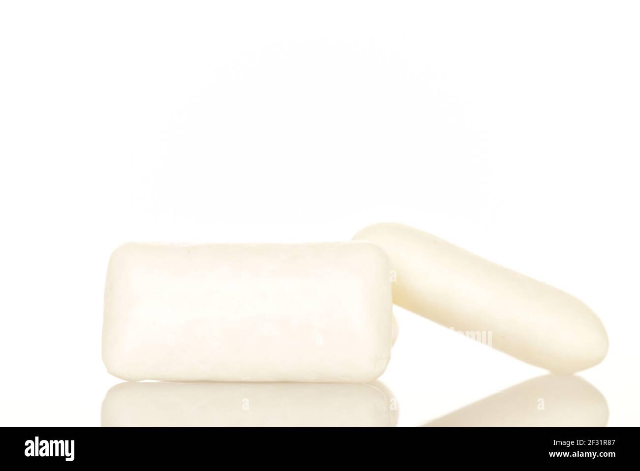 Two white fresh mint pads of chewing gum, close-up, on a white ...