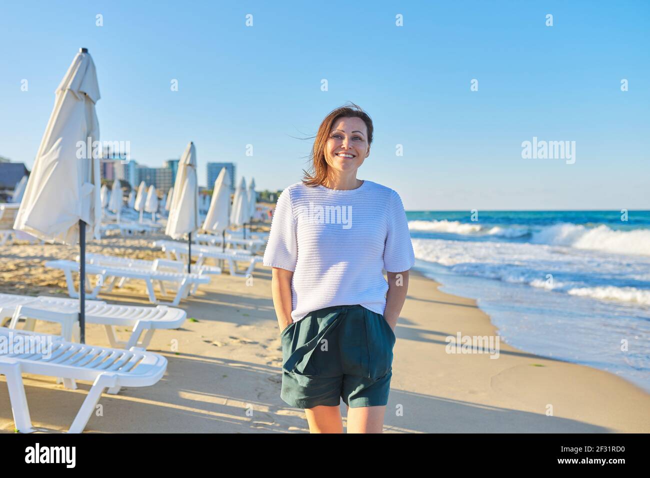 Portrait of happy smiling confident middle aged woman on beach Stock ...