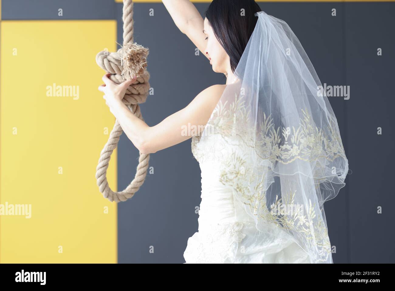 Woman in wedding dress holds her hand on loop for neck Stock Photo - Alamy