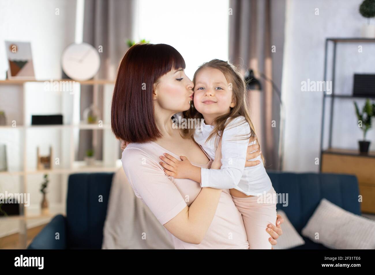 Lovely family mom and child. Happy affectionate young mother, holds her cute smiling little ...